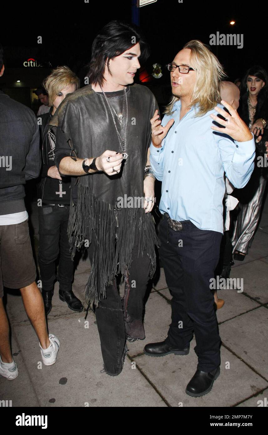 Pop singer Adam Lambert smiles and chats with friends as he arrives at ...