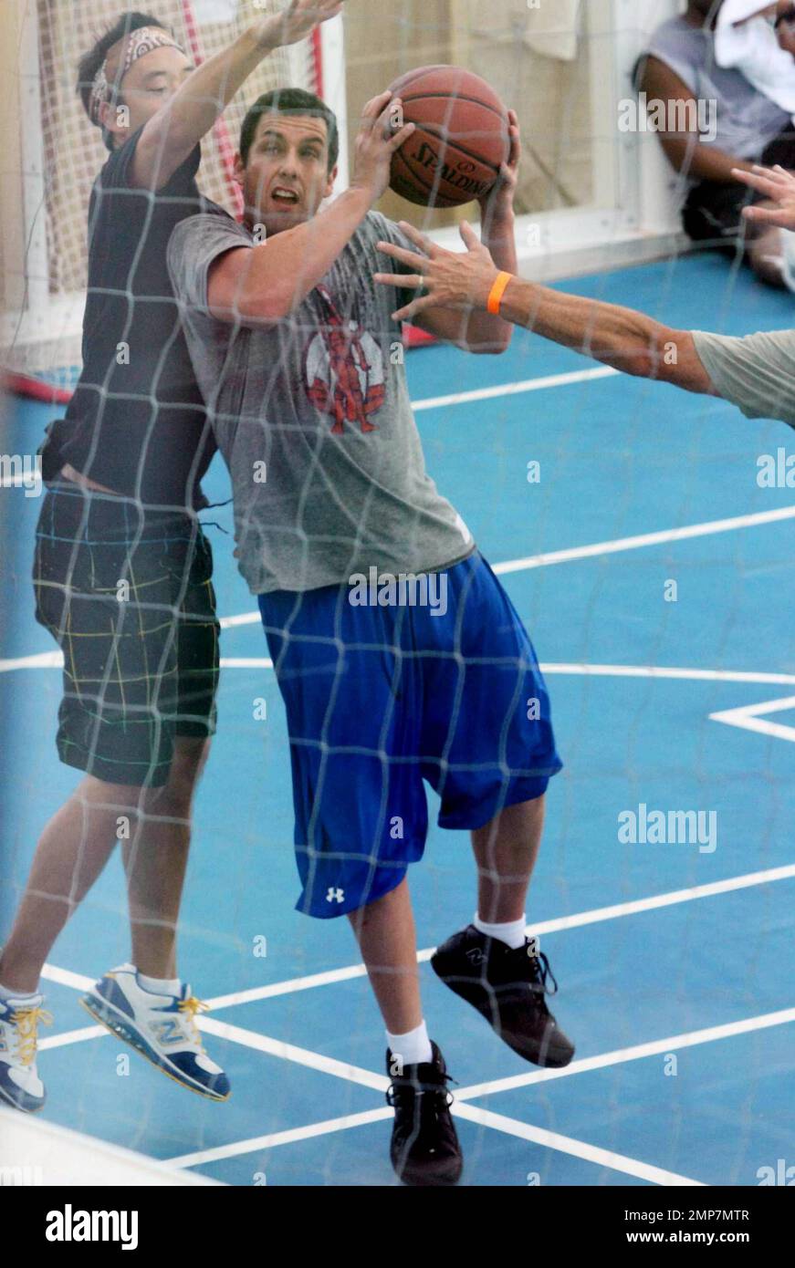 Actor Adam Sandler enjoys some downtime by playing basketball on the ...
