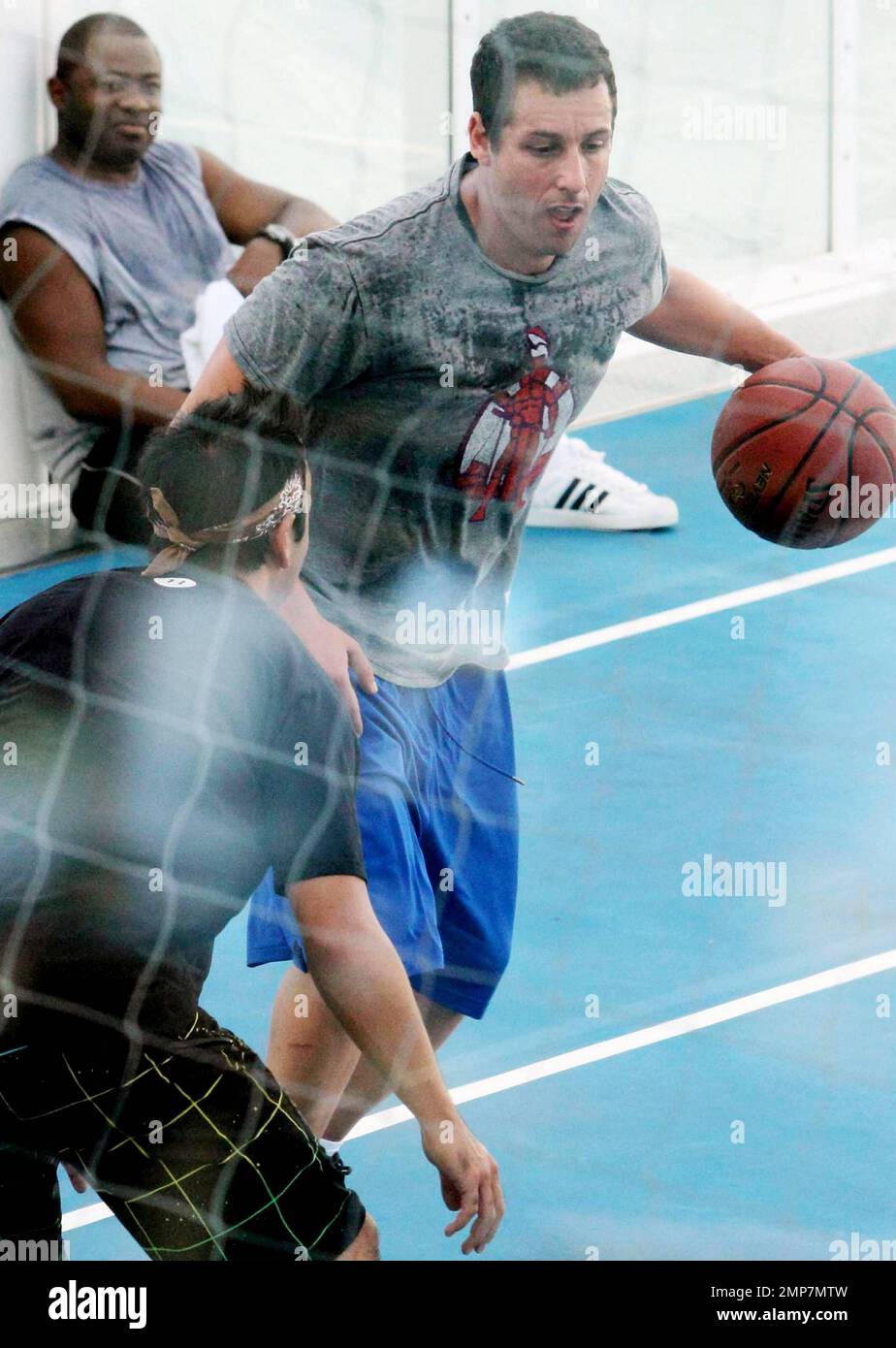 Actor Adam Sandler enjoys some downtime by playing basketball on the ...