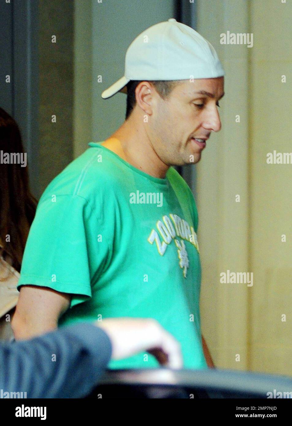 Adam Sandler flashes a peace sign as he leaves his luxury hotel with ...