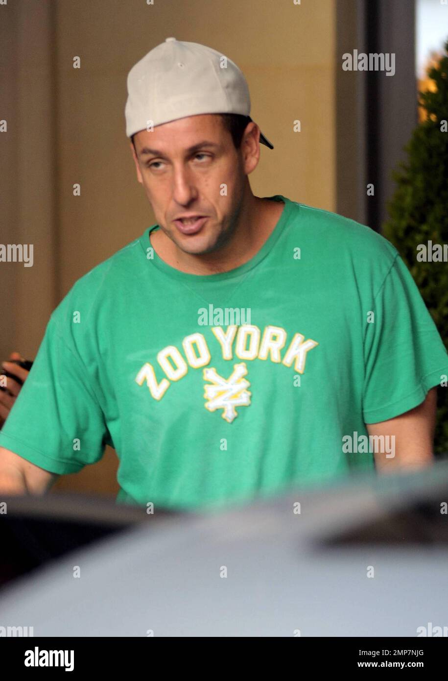 Adam Sandler flashes a peace sign as he leaves his luxury hotel with ...