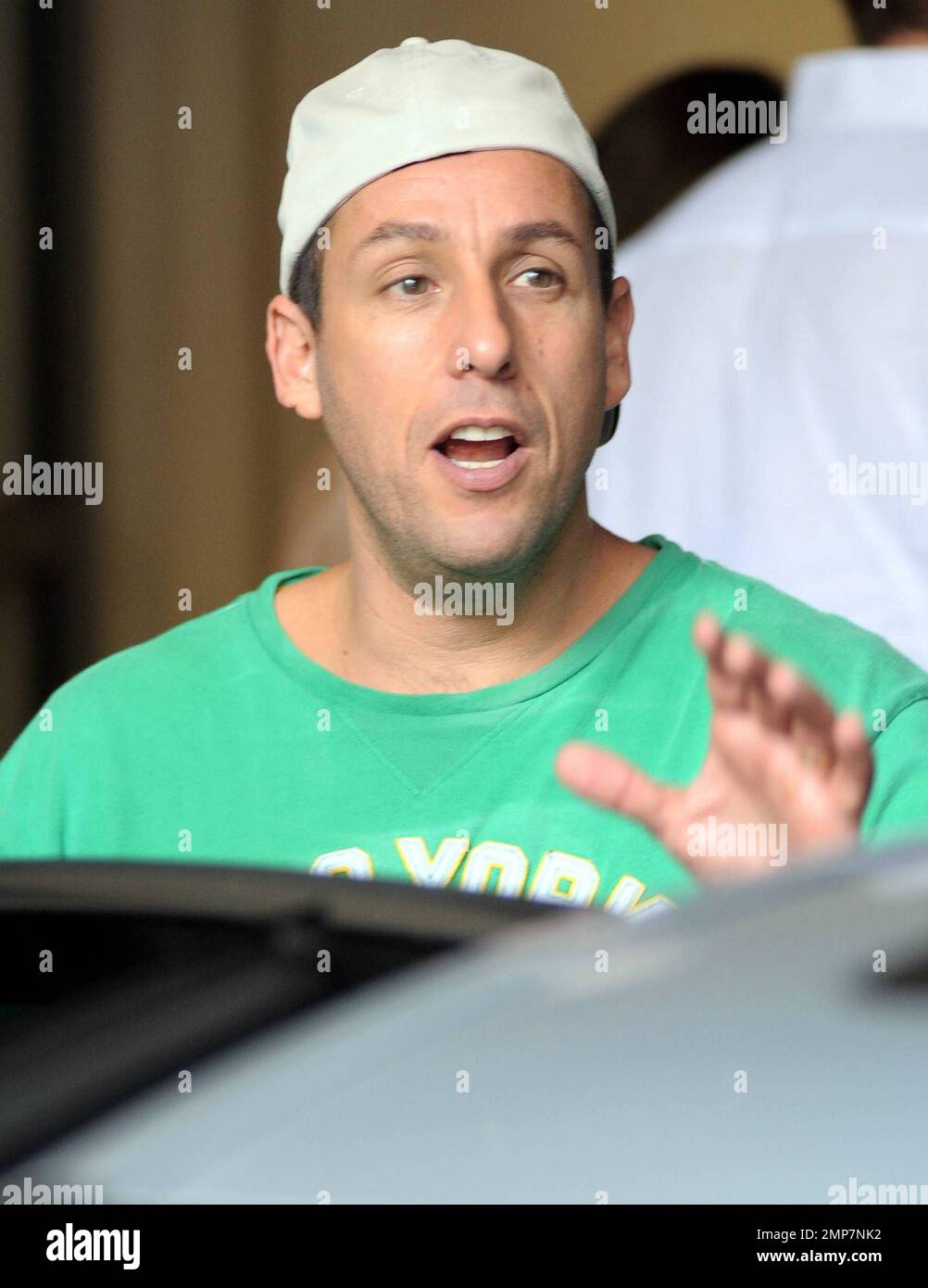 Adam Sandler flashes a peace sign as he leaves his luxury hotel with ...