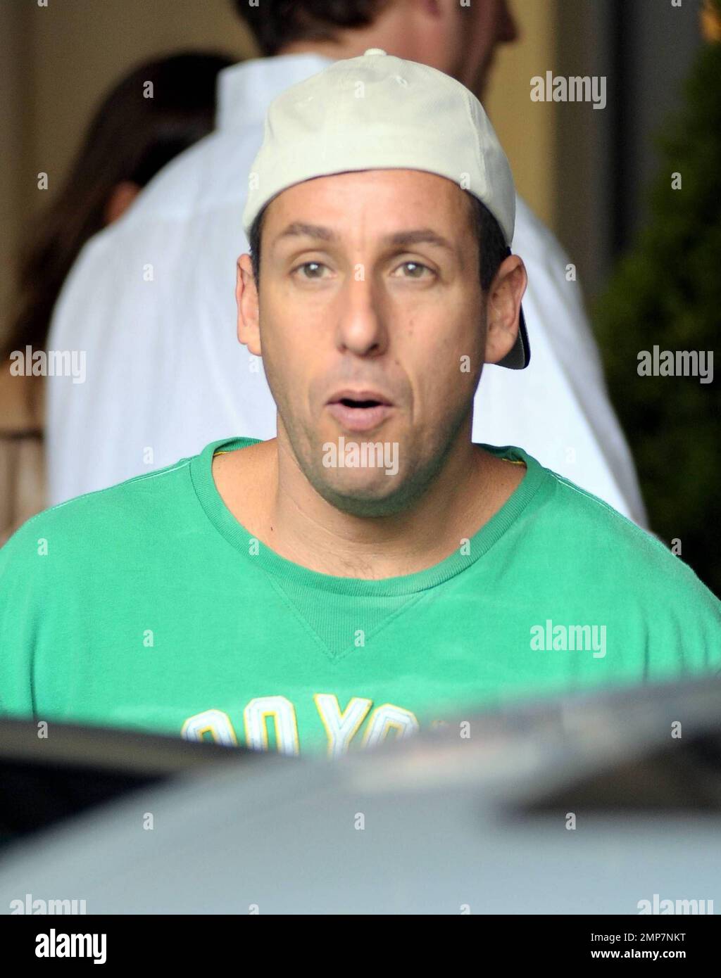 Adam Sandler flashes a peace sign as he leaves his luxury hotel with ...