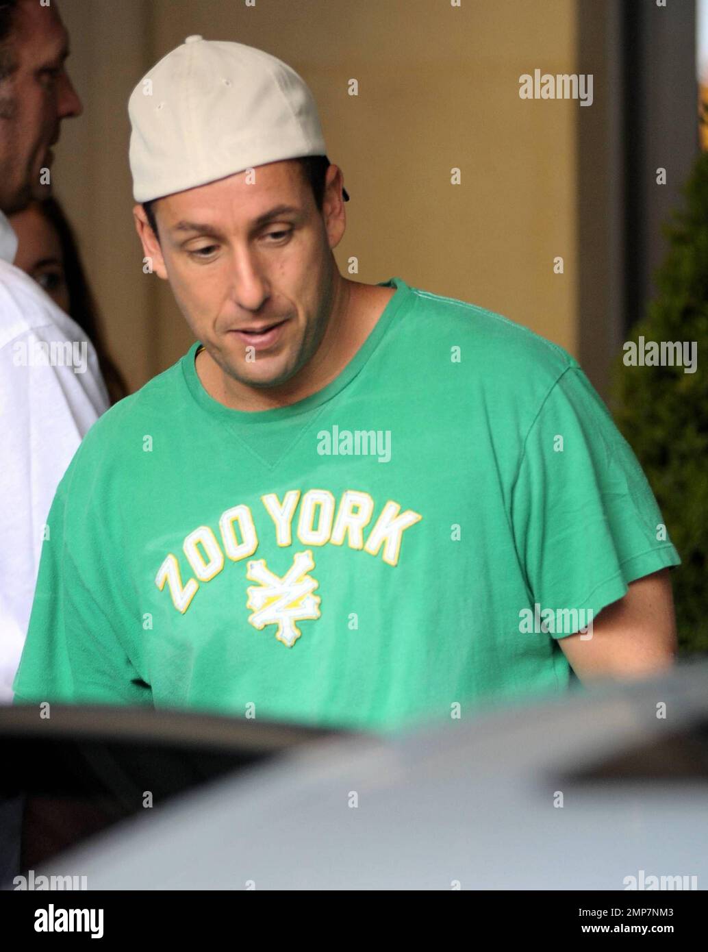 Adam Sandler flashes a peace sign as he leaves his luxury hotel with ...