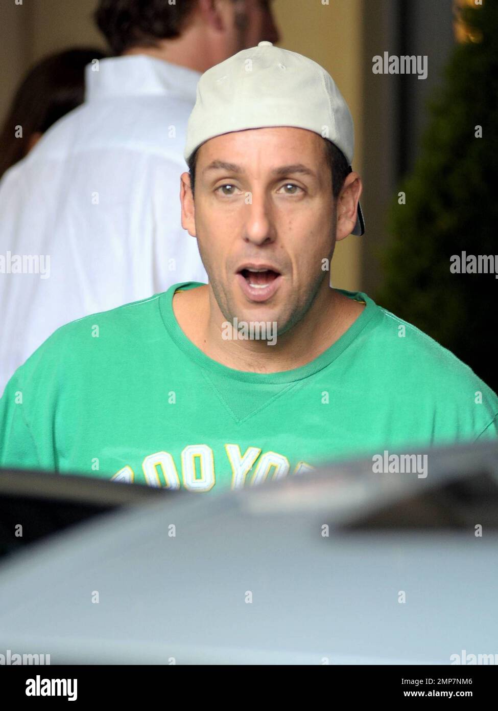 Adam Sandler flashes a peace sign as he leaves his luxury hotel with ...