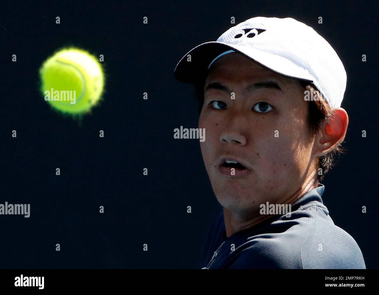 Japan's Yoshihito Nishioka eyes on the ball while playing Germany's Philipp Kohlschreiber during ...