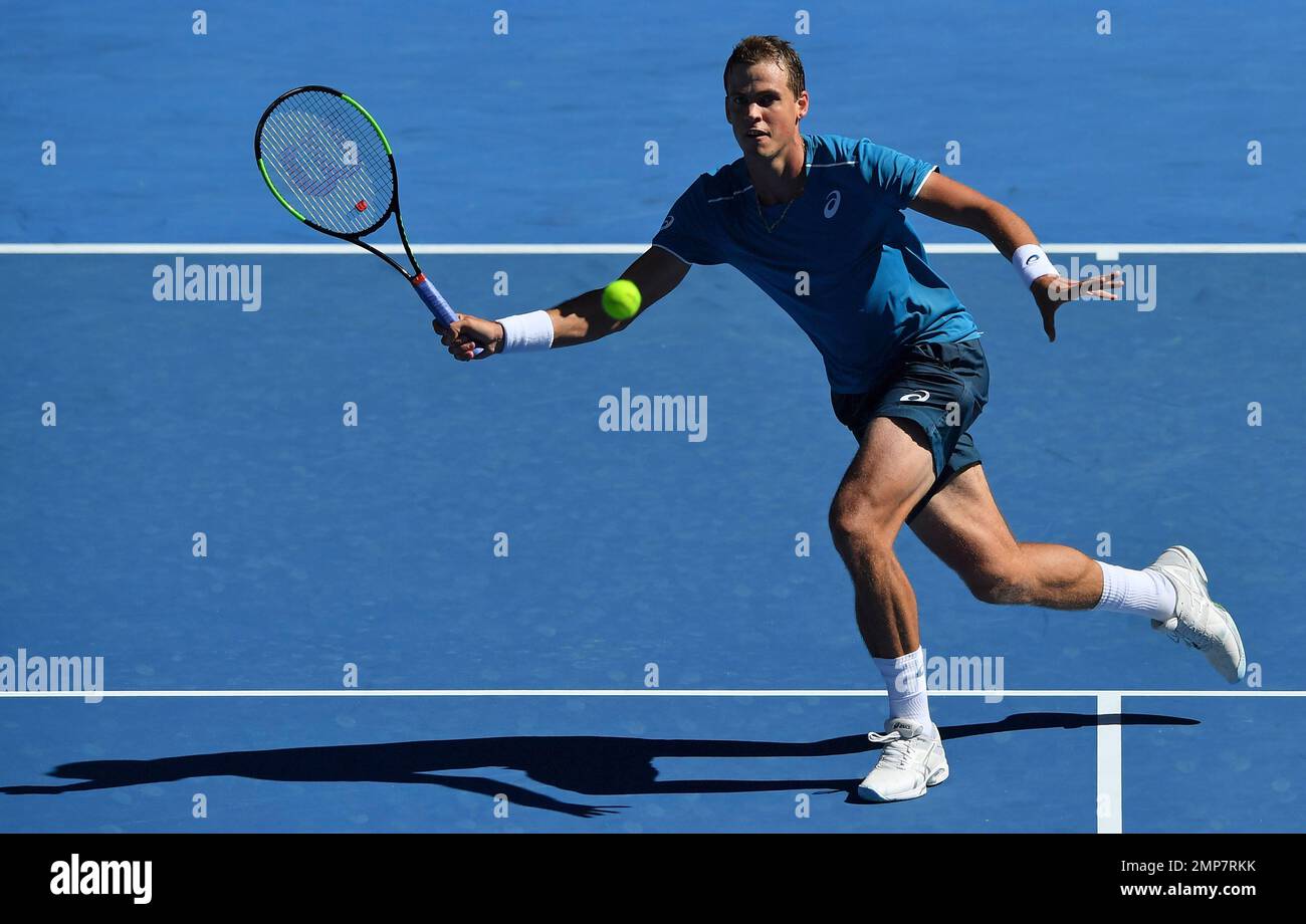 Canada's Vasek Pospisil runs to make a forehand return to Croatia's ...
