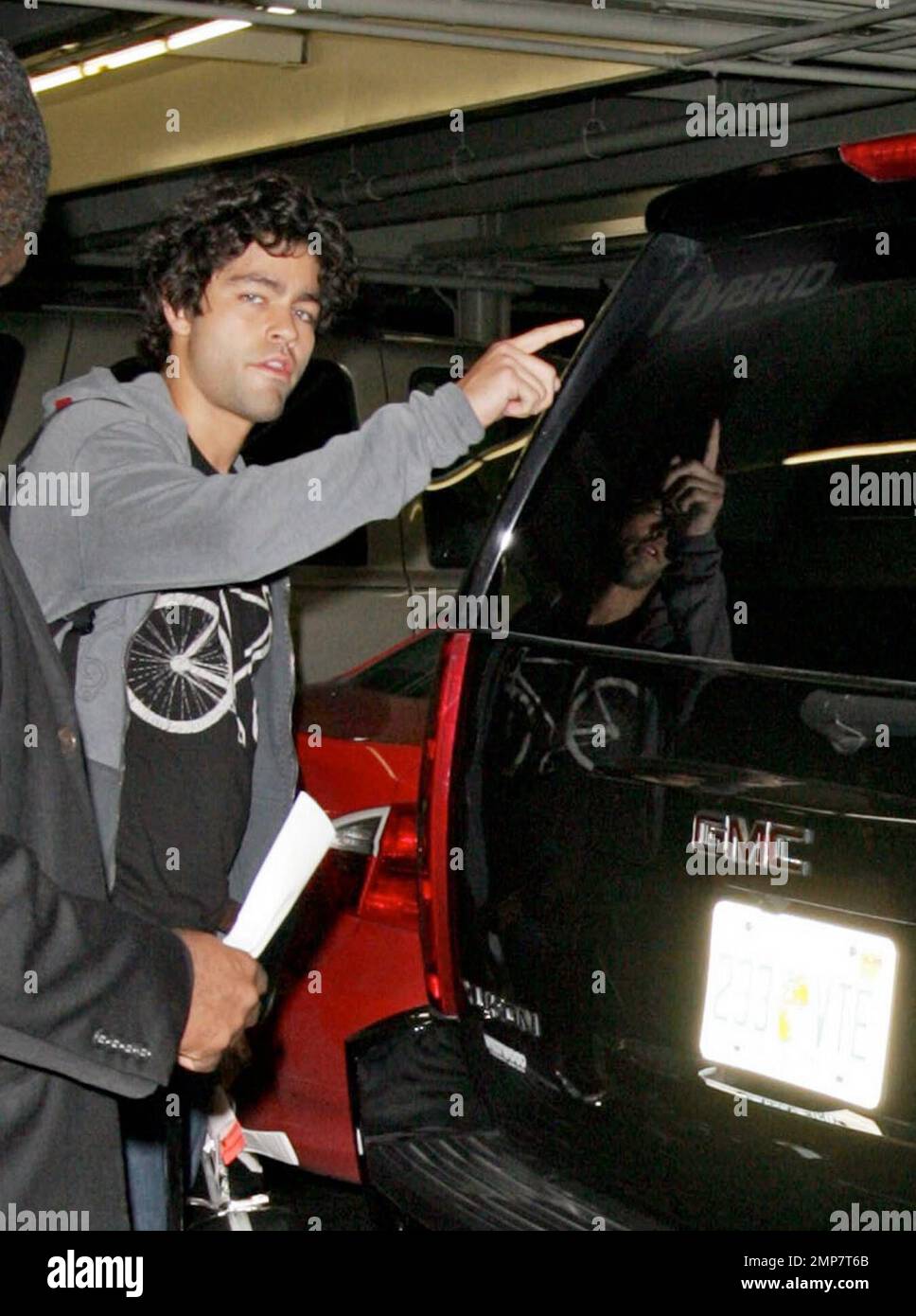 Adrian Grenier arrives at Miami International Airport with his The ...