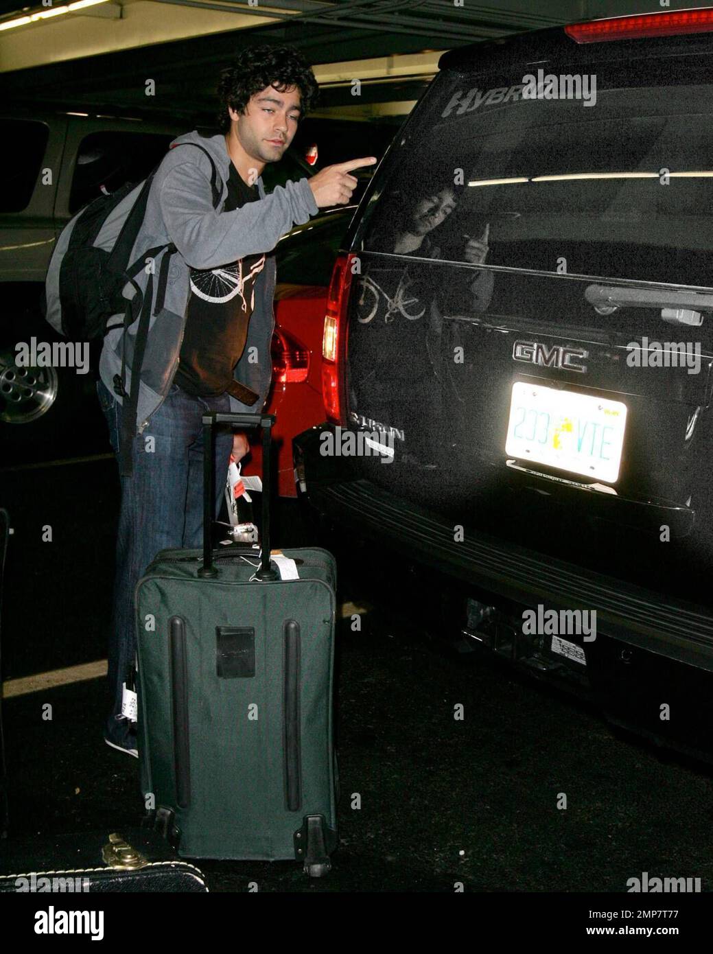 Adrian Grenier arrives at Miami International Airport with his The ...