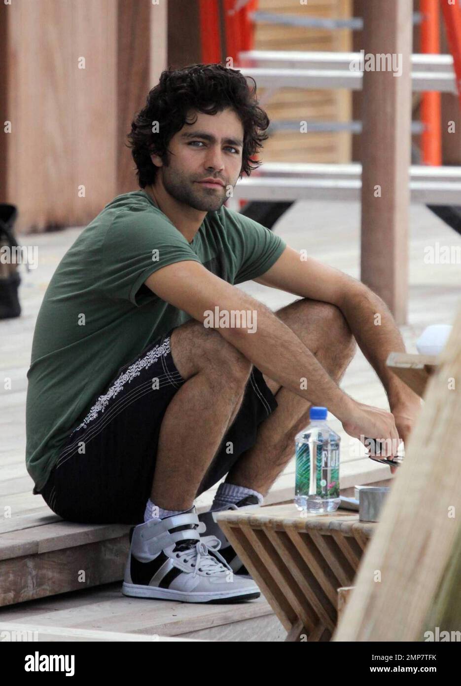 Adrian Grenier and his "entourage" lounge poolside. The actor is in ...