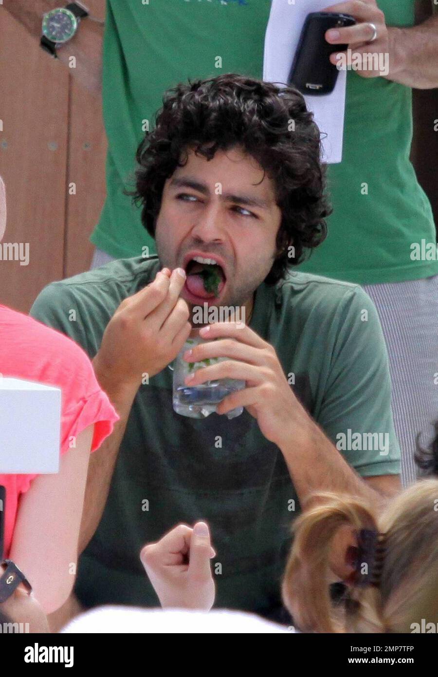 Adrian Grenier and his "entourage" lounge poolside. The actor is in ...