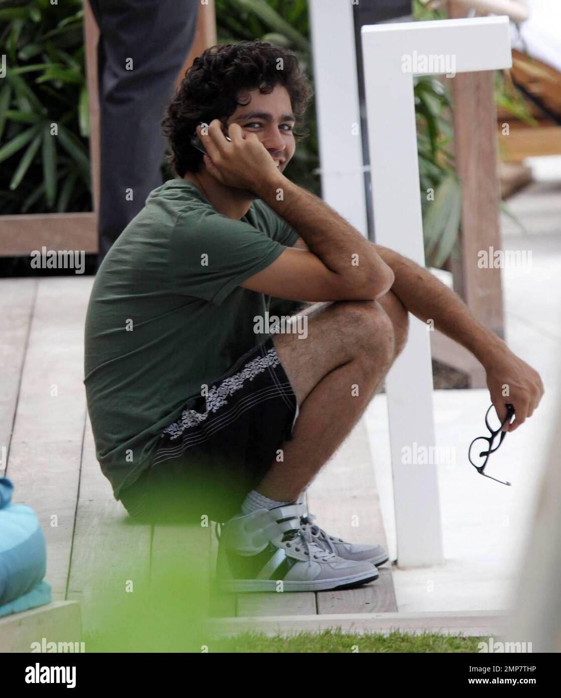 Adrian Grenier and his "entourage" lounge poolside. The actor is in ...