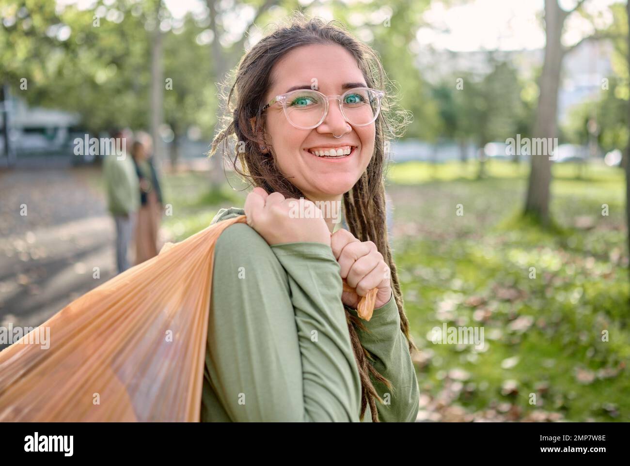 Plastic bag, park and happy woman for eco friendly cleaning on earth ...