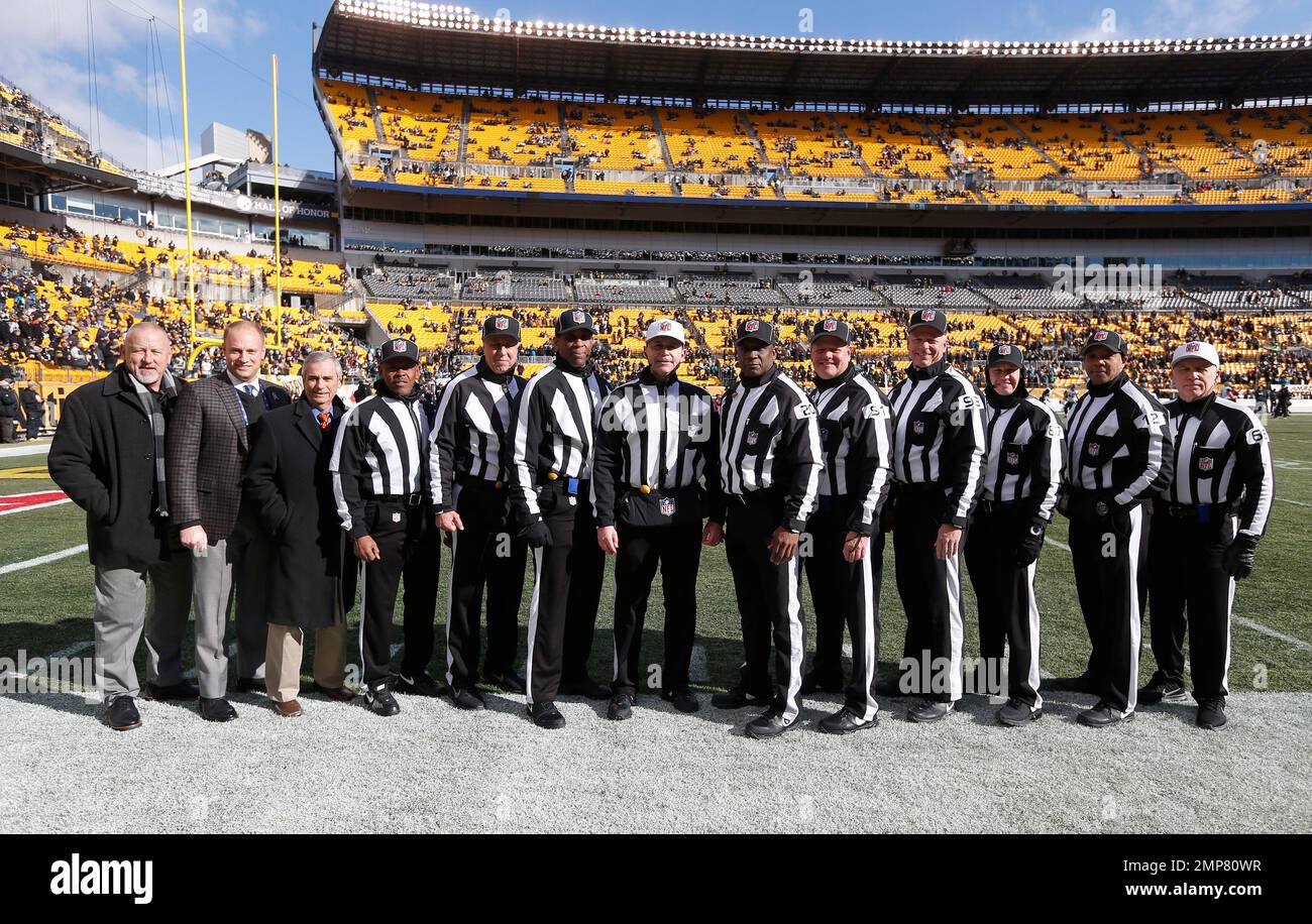 Officials pose for a photo before an NFL divisional football AFC ...