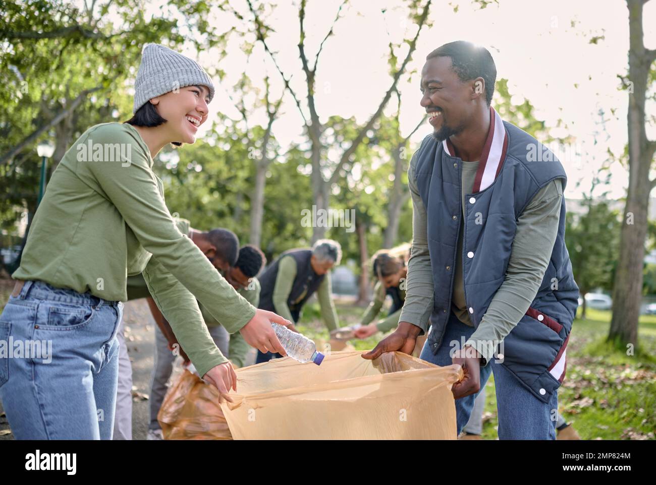 Community volunteer, teamwork and cleaning park of plastic with garbage ...