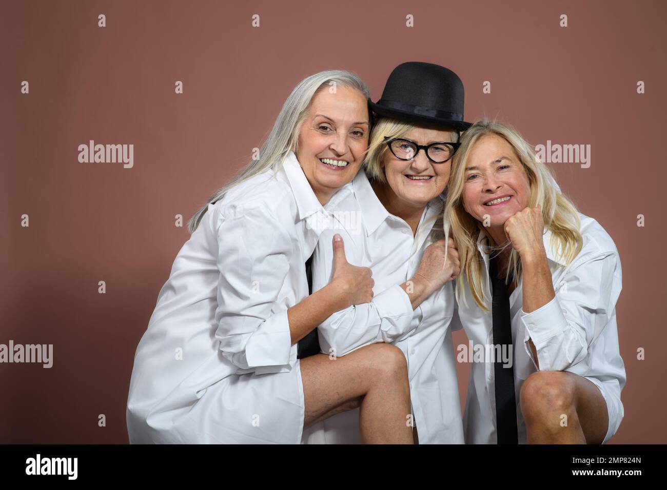 Portrait of three happy senior friends in studio Stock Photo - Alamy