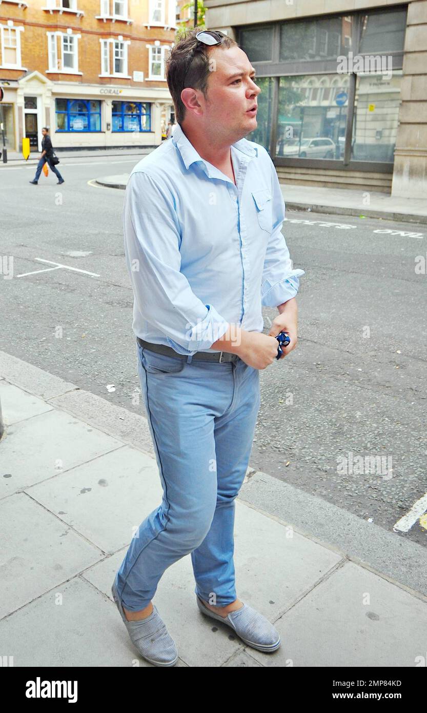 Radio and TV personality Alan Carr arrives at the BBC and poses for ...