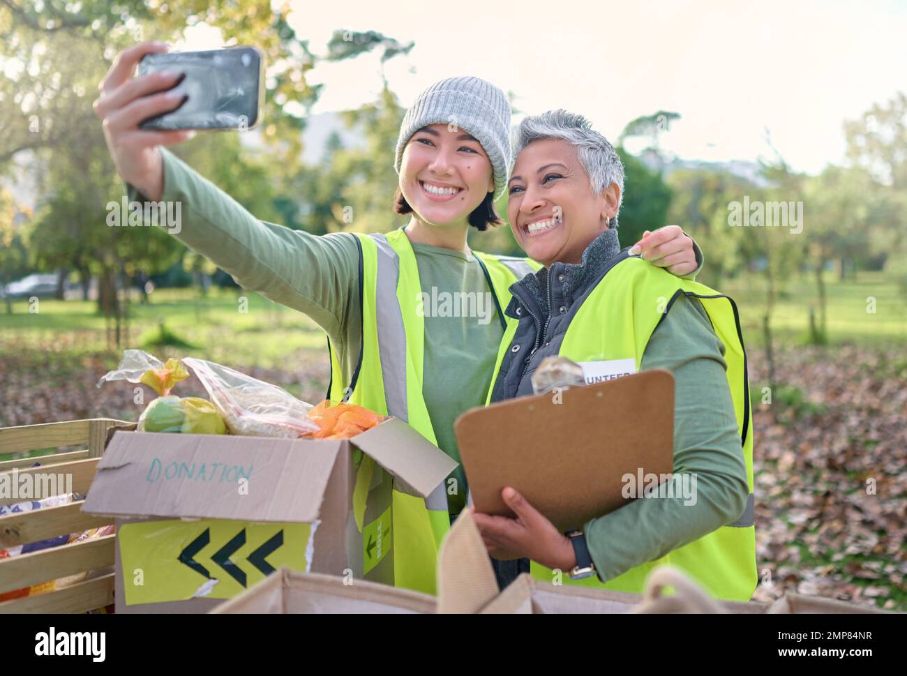 Selfie, volunteer and donation with a woman charity or relief worker ...
