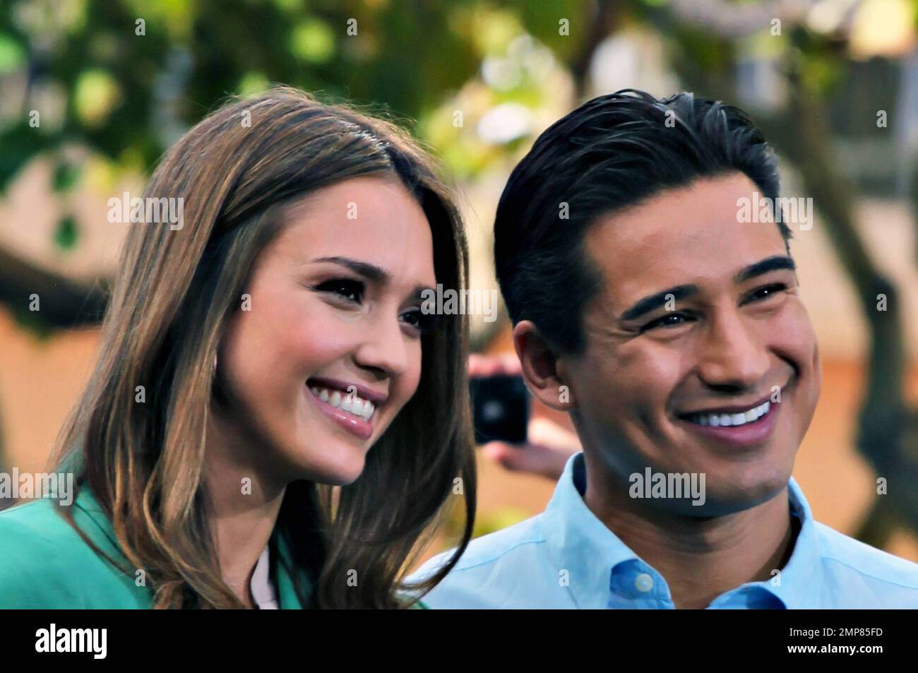 Jessica Alba poses for photos with Mario Lopez during an interview at ...
