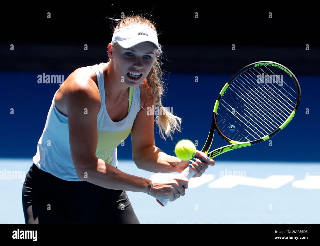 Denmark's Caroline Wozniacki hits a backhand return during a practice ...
