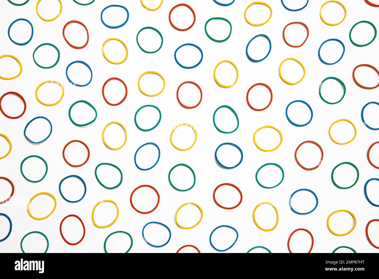 Flat lay colourful rubber band background. Office supply, elastic band ...