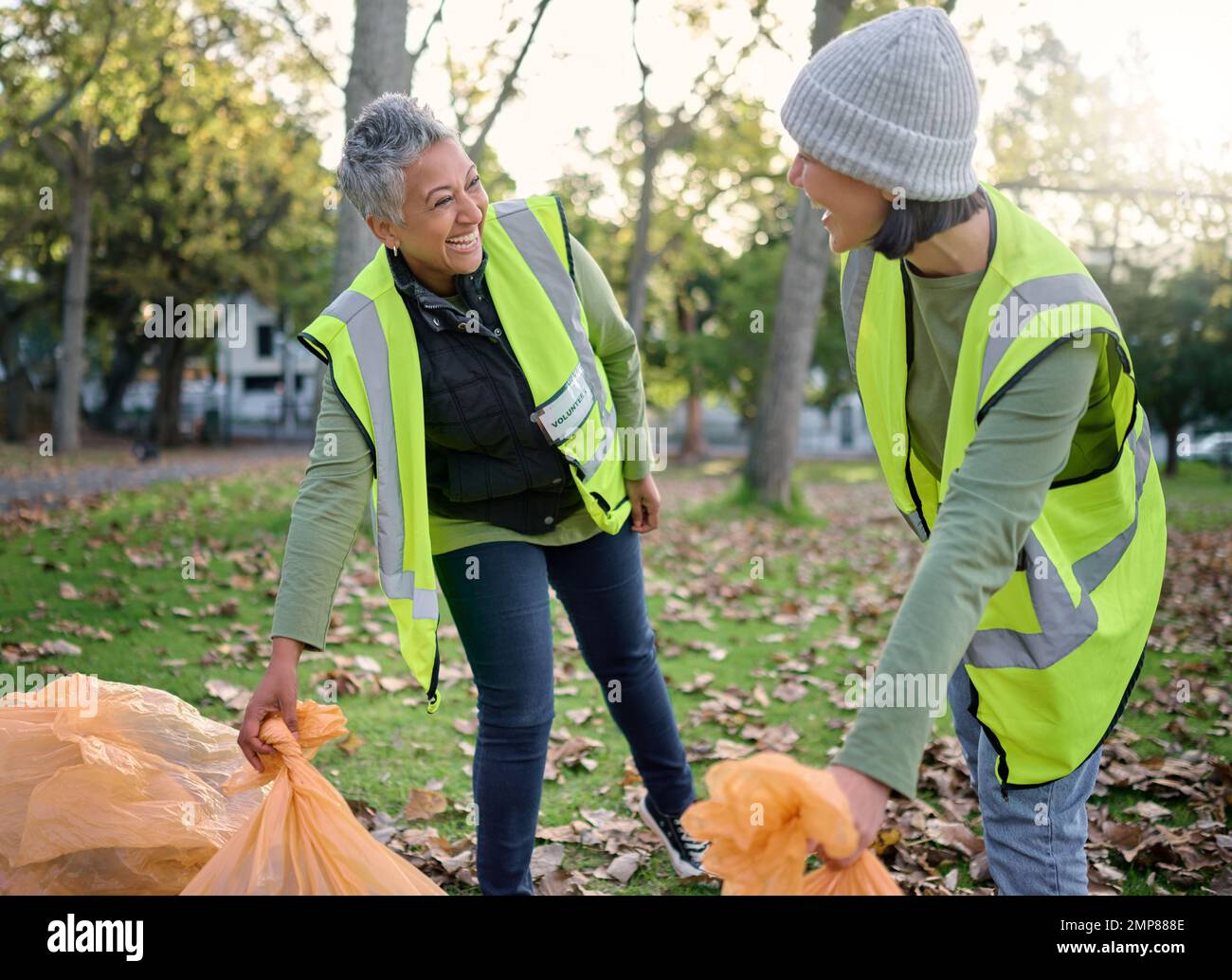 Volunteer, happy women and community service while cleaning park with ...