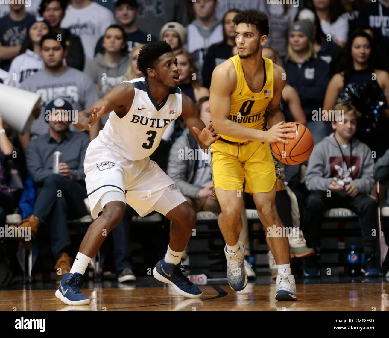 Marquette guard Markus Howard (0) looks to pass around Butler guard ...