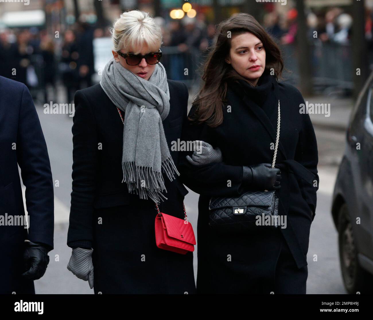 French actress Cecile Cassel, left, arrives at the Montmartre cemetery ...