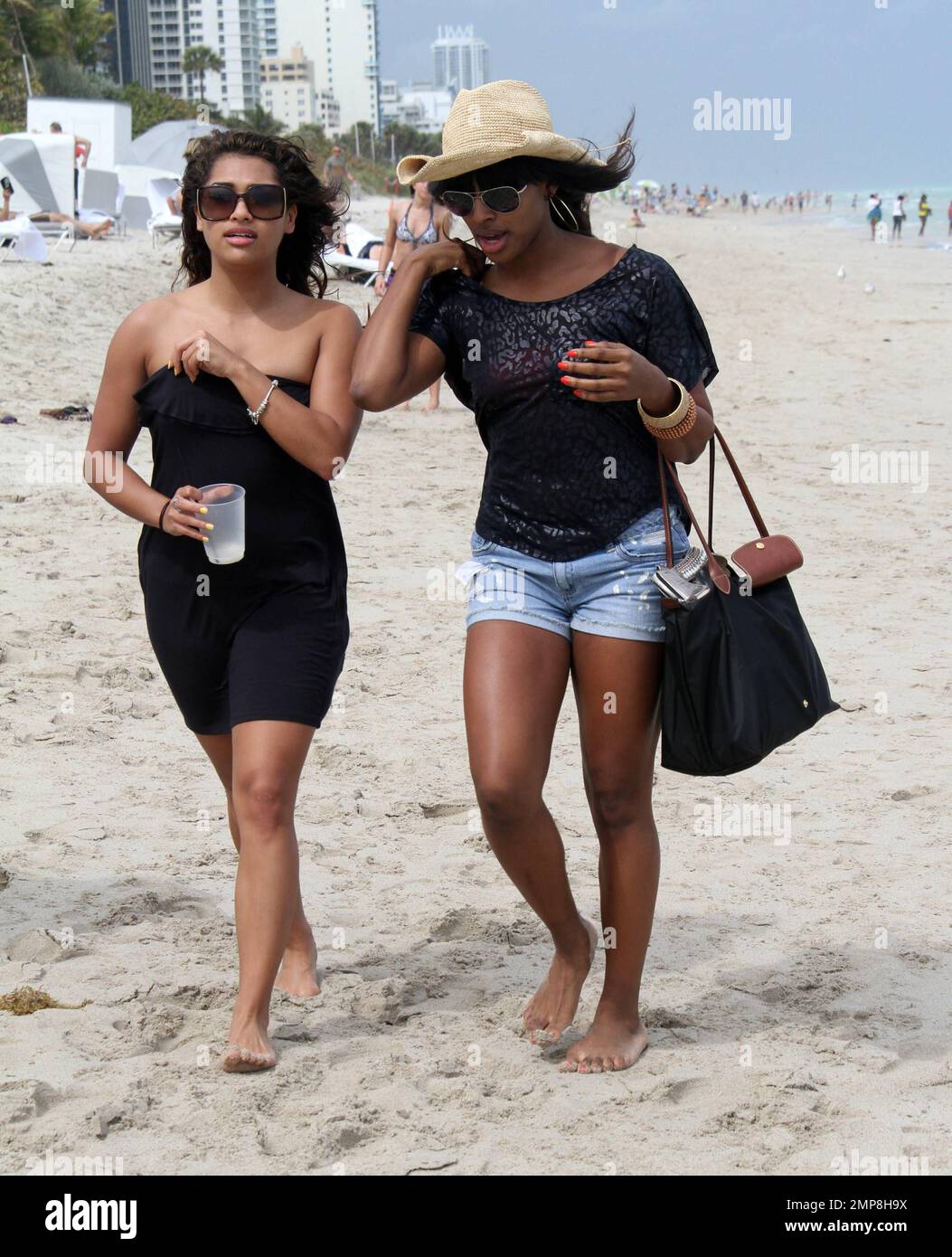 Wearing denim short shorts, UK singer Alexandra Burke chats to friends ...