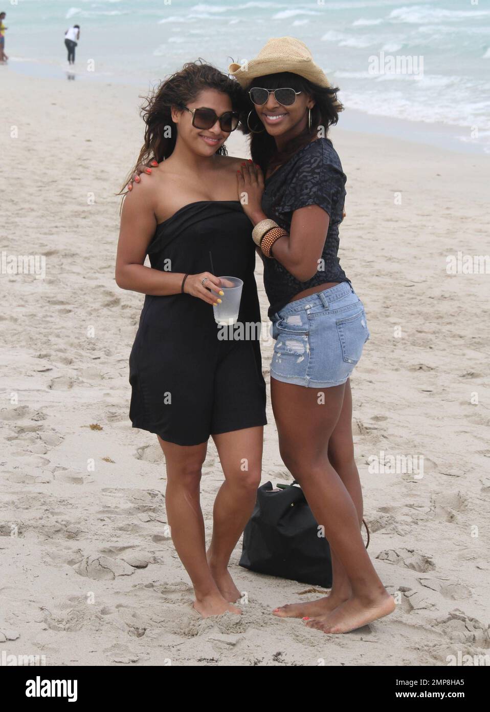 Wearing denim short shorts, UK singer Alexandra Burke chats to friends ...