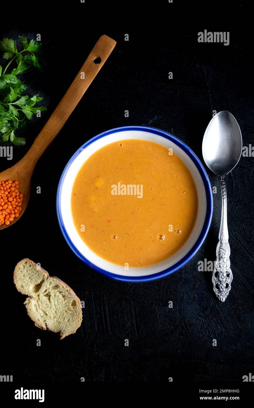 Red lentil soup puree in a bowl n dark background. Traditional middle ...