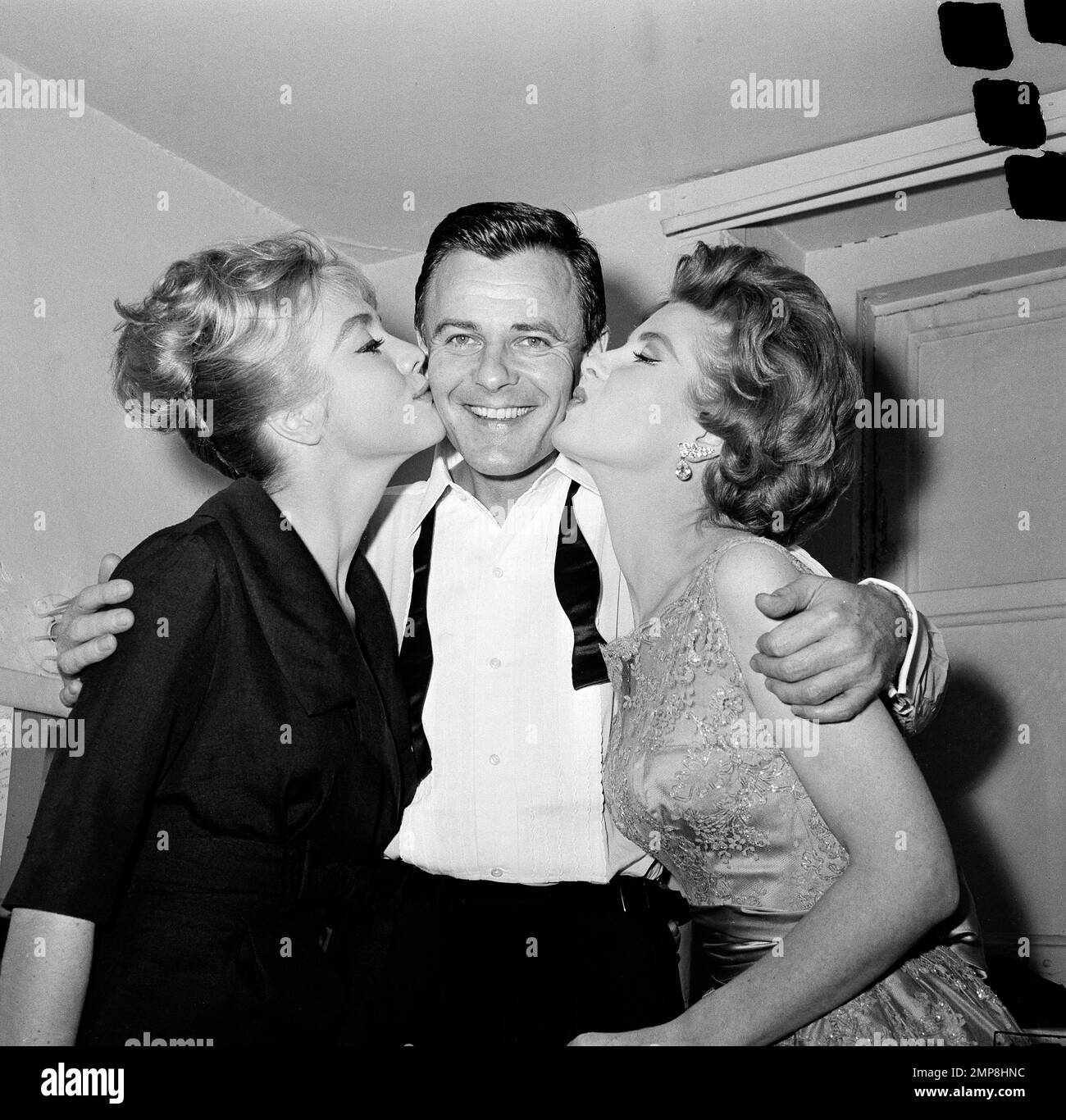 Robert Sterling gets a kiss from Inger Stevens, left, and Julia Meade ...