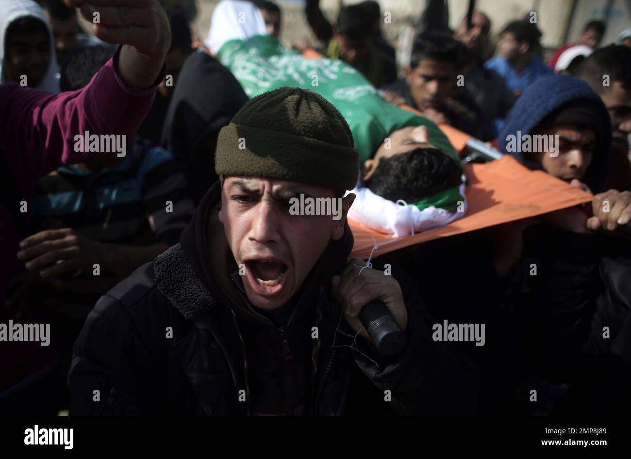 Mourners chant angry slogans as they carry the body of 16-year-old ...
