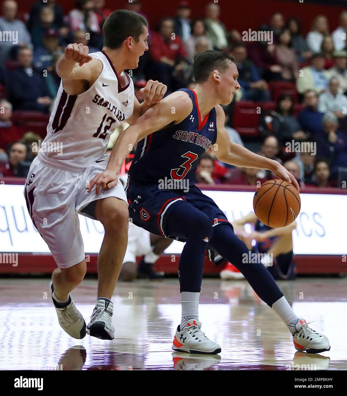 Saint Mary's Emmett Naar, right, drives the ball against Santa Clara's ...