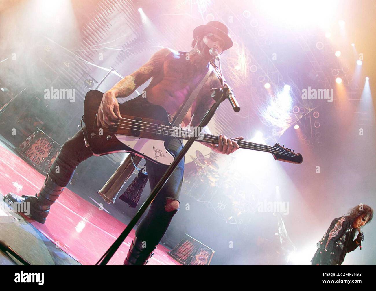 Alice Cooper stays true to his dark style as he rocks out in tight ...