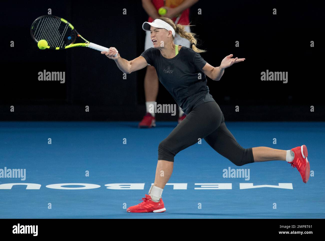 Denmark's Caroline Wozniacki makes a forehand return during a practice ...