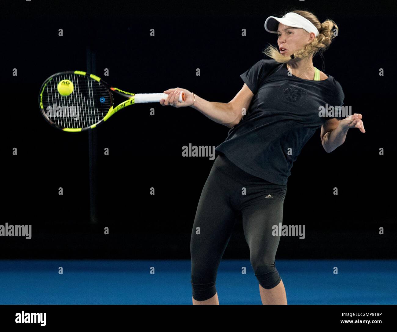 Denmark's Caroline Wozniacki makes a forehand return during a practice ...
