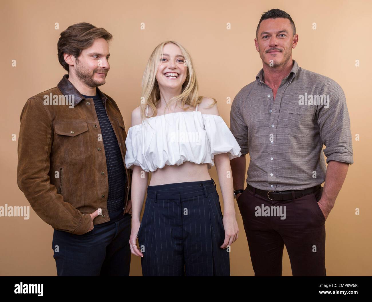 Daniel Brühl, from left, Dakota Flanning and Luke Evans cast members in ...