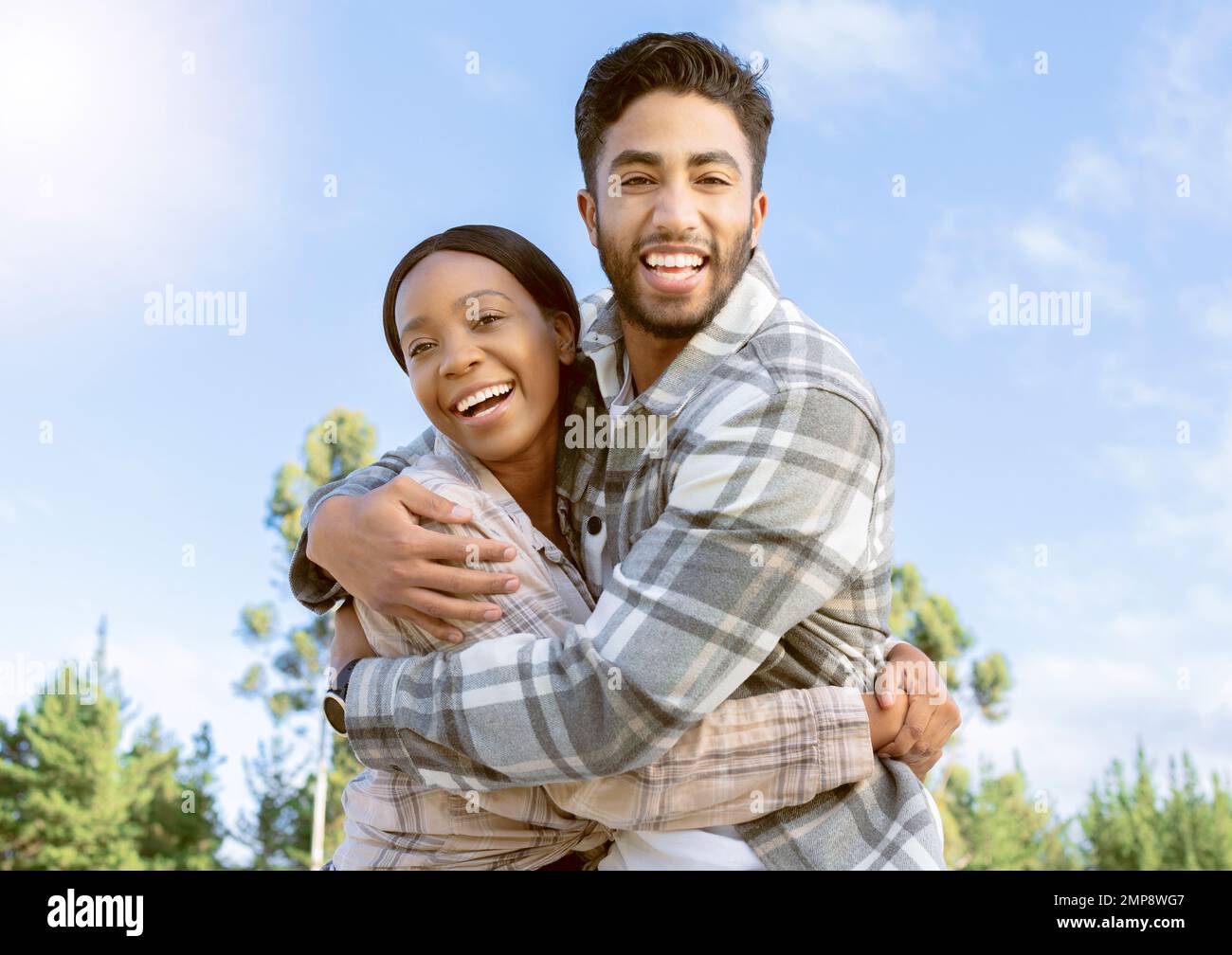 Portrait, couple of friends and hug while hiking in nature, forest and ...