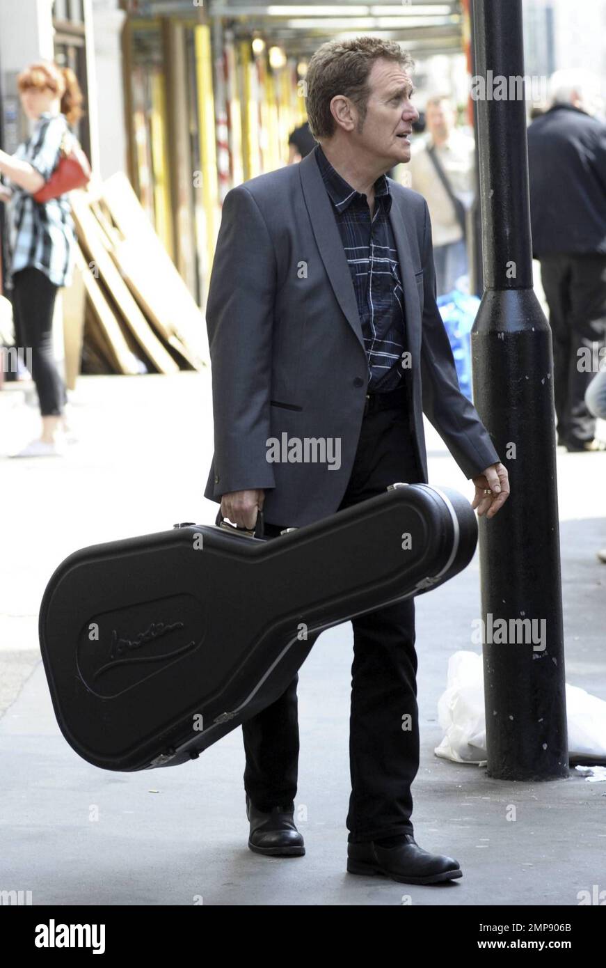 '70s pop icon Alvin Stardust (Shane Fenton) carries his guitar as he ...