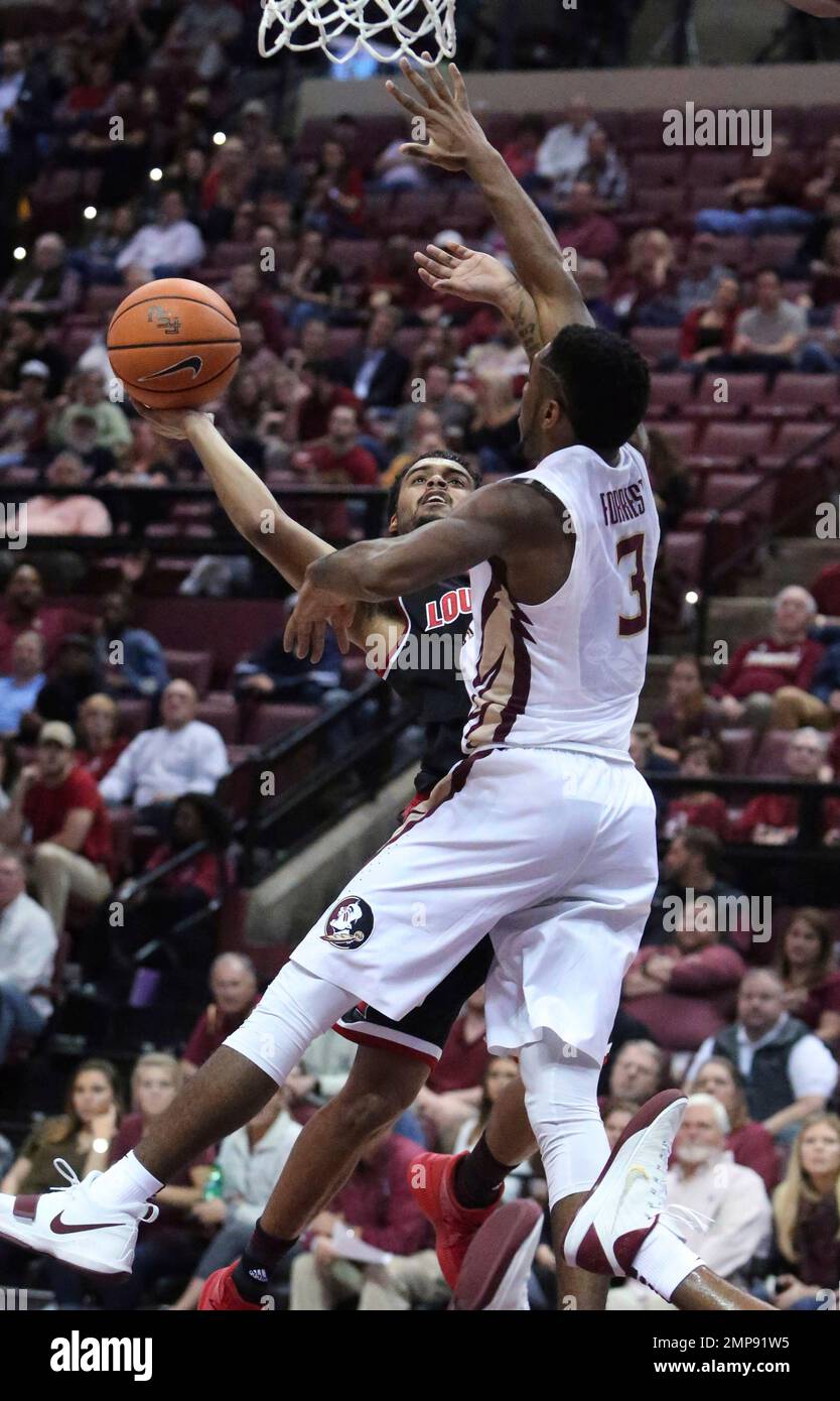 Louisville's Quentin Snider, rear, shoots against Florida State's Trent ...