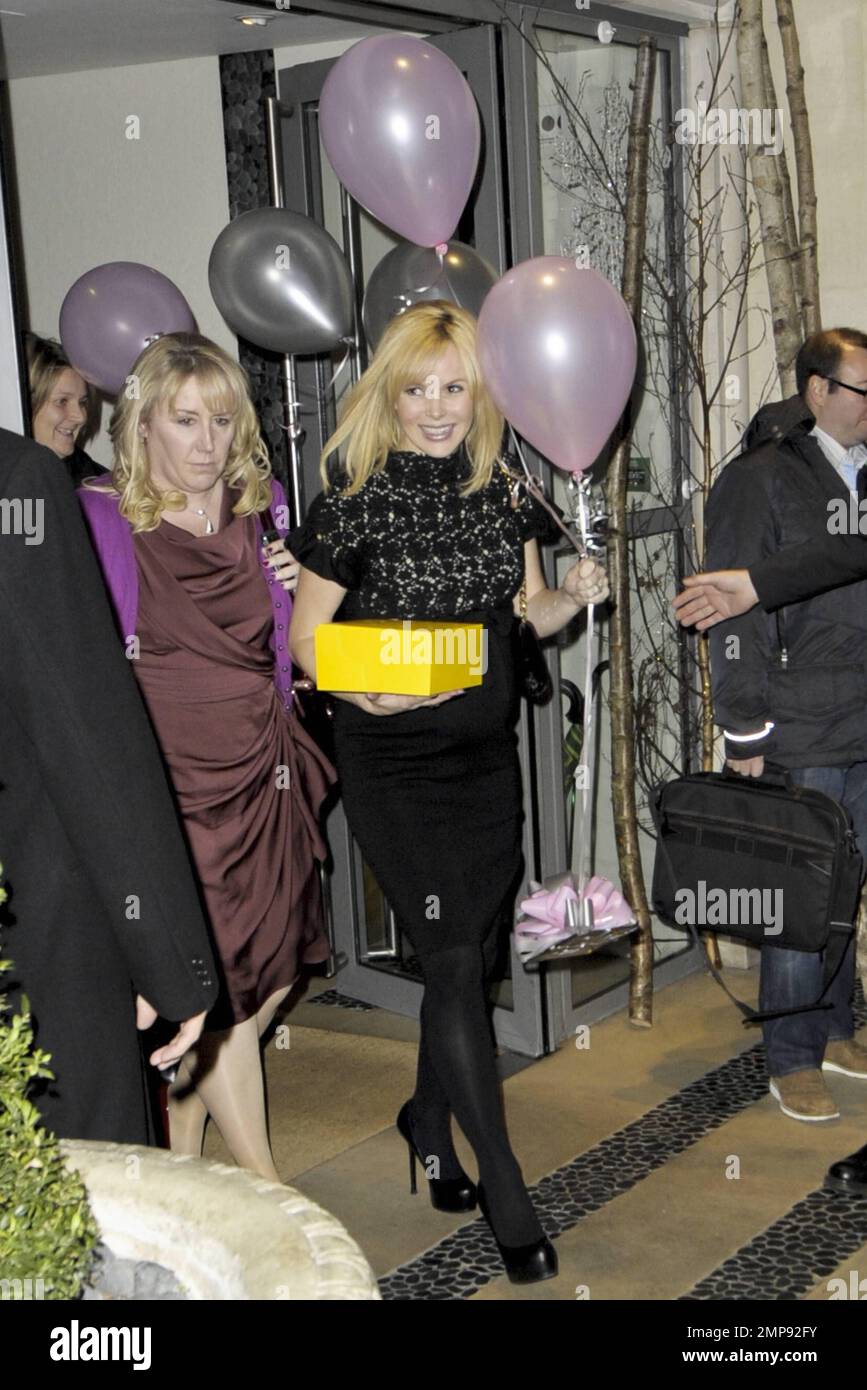 Amanda Holden manages a bunch of balloons as she leaves her baby shower ...