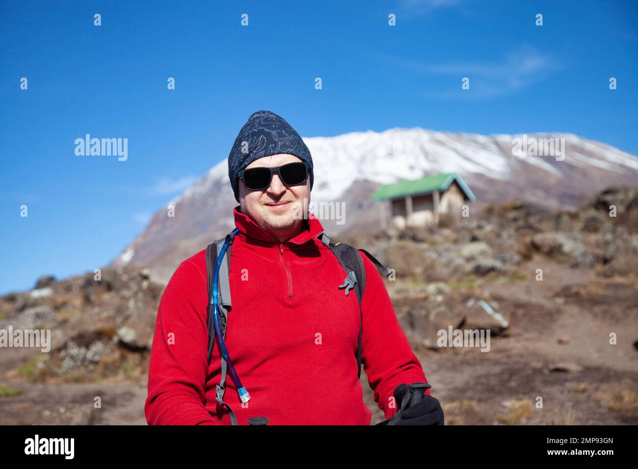 Male backpacker on the trek to Kilimanjaro mountain Stock Photo - Alamy