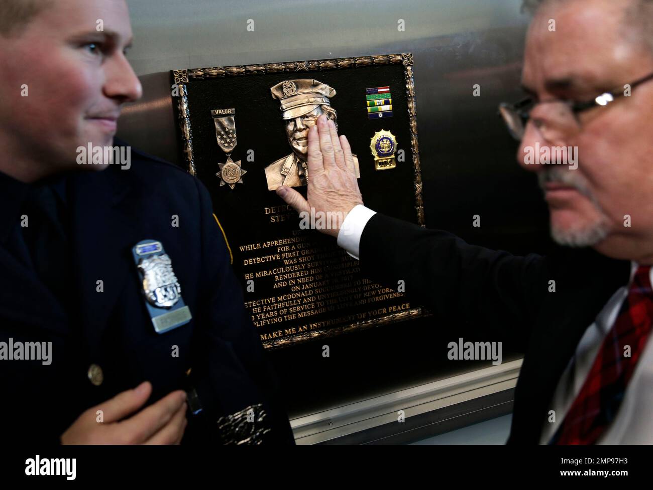 People get a closer look at a memorial plaque for NYPD Detective Steven ...