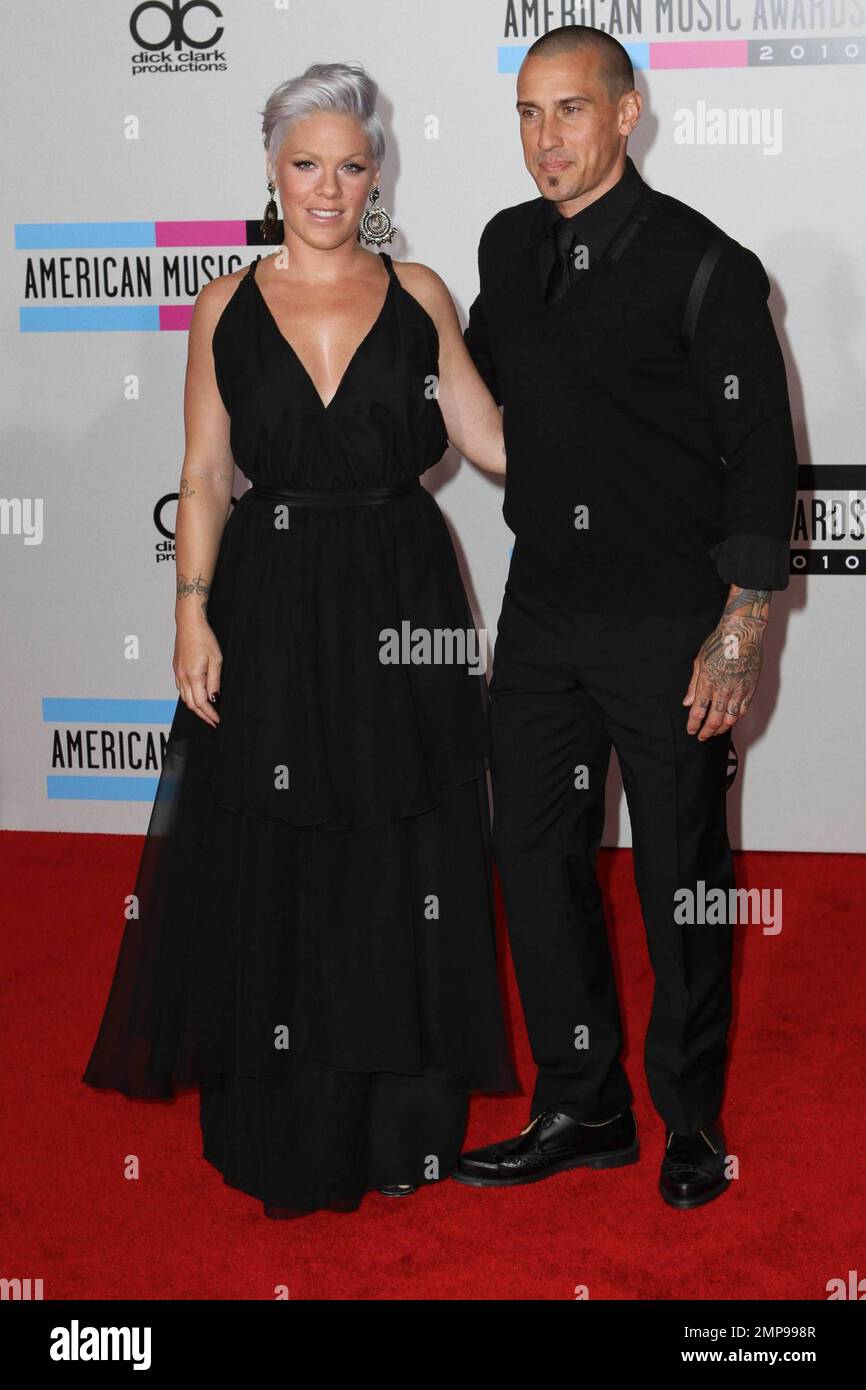 Pink shows off her stylized grey hair as she walks the red carpet with ...