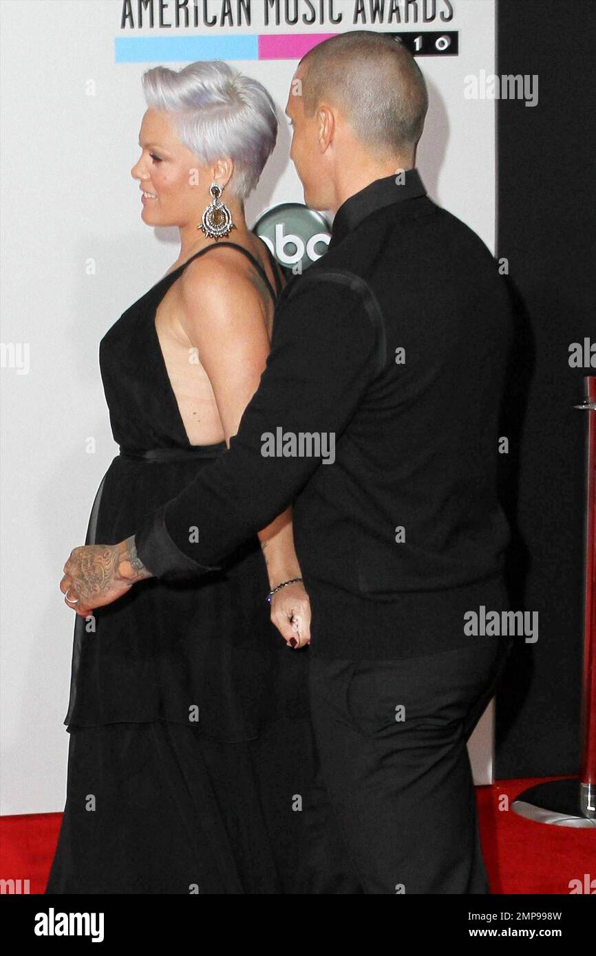 Pink shows off her stylized grey hair as she walks the red carpet with ...