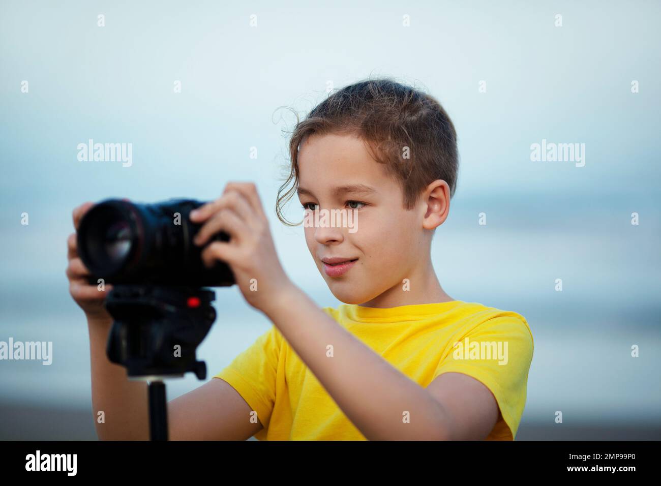 Teenage boy taking pictures with digital camera Stock Photo - Alamy