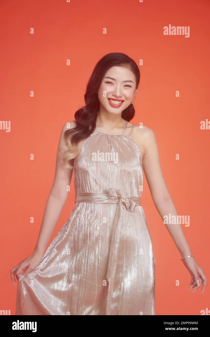 Studio portrait of tall girl in party attire posing on isolated ...