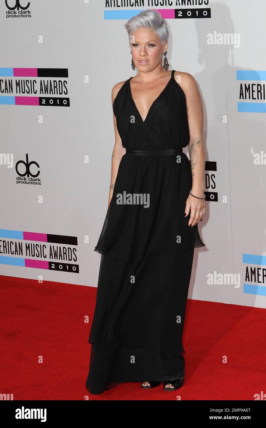 Pink shows off her stylized grey hair as she walks the red carpet with ...