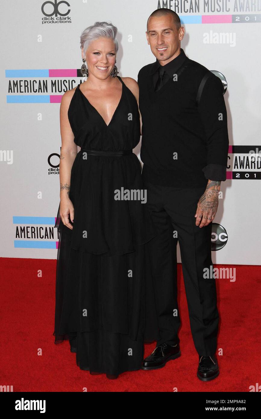 Pink shows off her stylized grey hair as she walks the red carpet with ...